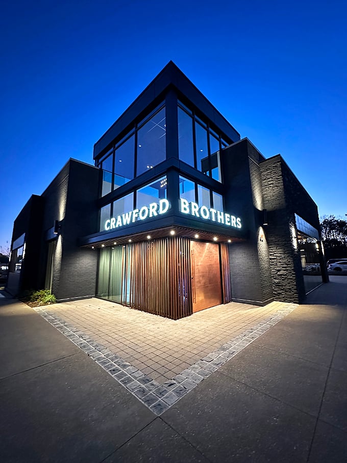 By night, this sleek steakhouse glows like a beacon for hungry travelers seeking beef perfection.