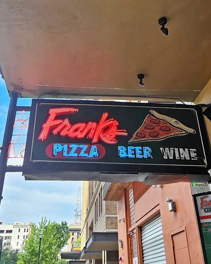 The iconic Frank's Pizza sign glows like a beacon for hungry Houstonians. That perfect fold-worthy slice awaits inside.