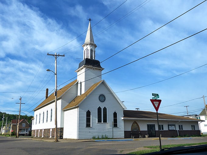 A white church steeple punctuates Ishpeming's skyline, where faith in community remains as solid as the town's mining foundations.