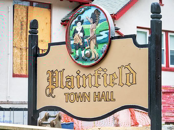 The historic Plainfield Town Hall sign features a colorful colonial-era scene, highlighting the town's rich heritage and community pride.
