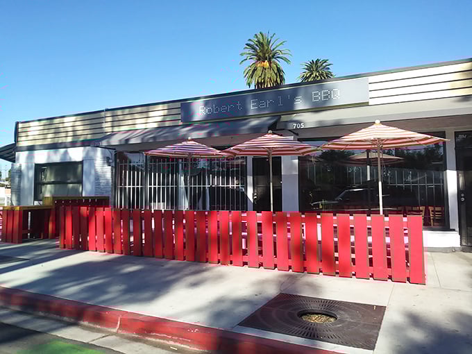Sunshine, palm trees, and serious BBQ – Robert Earl's outdoor seating area invites you to linger over brisket.
