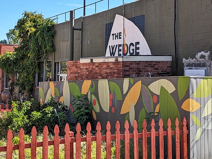 Fresh herbs and vegetables grow just steps from your pizza at The Wedge. That painted fence isn't just decorative—it's protecting future toppings!