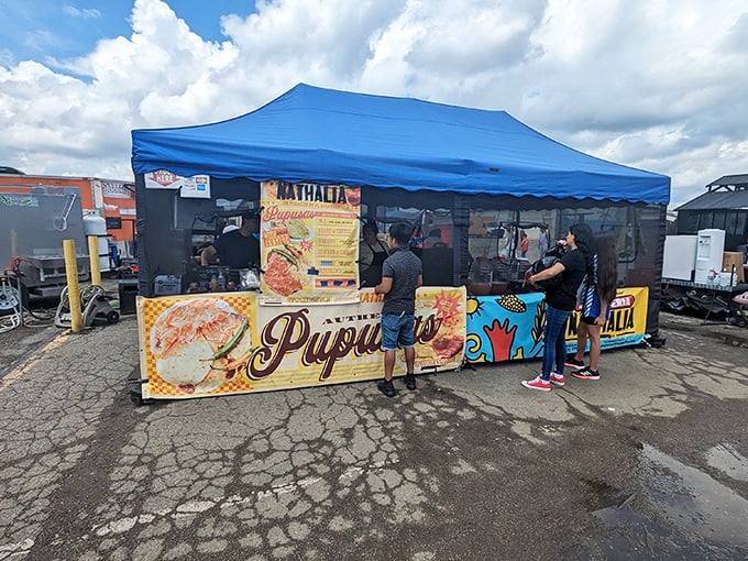 Hungry shoppers line up at a colorful pupusa stand – one of many delicious food options that fuel serious bargain hunters at Ohio's flea markets!