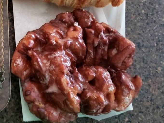 This apple fritter isn't just breakfast—it's a craggy mountain of glazed perfection that makes you forget you ever knew what a diet was.