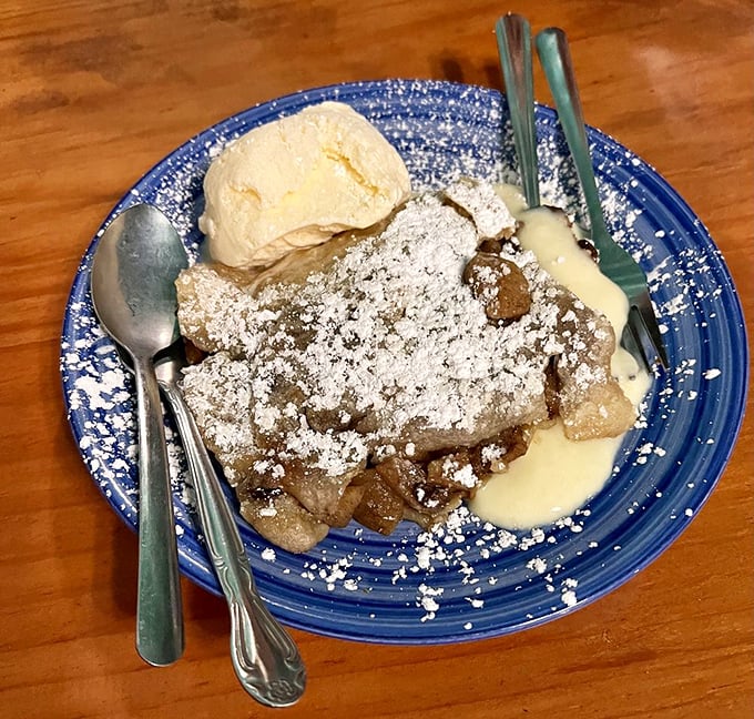 Dessert that demands a moment of silence. Apple strudel dusted with powdered sugar and served with vanilla ice cream—simple pleasures elevated to art.