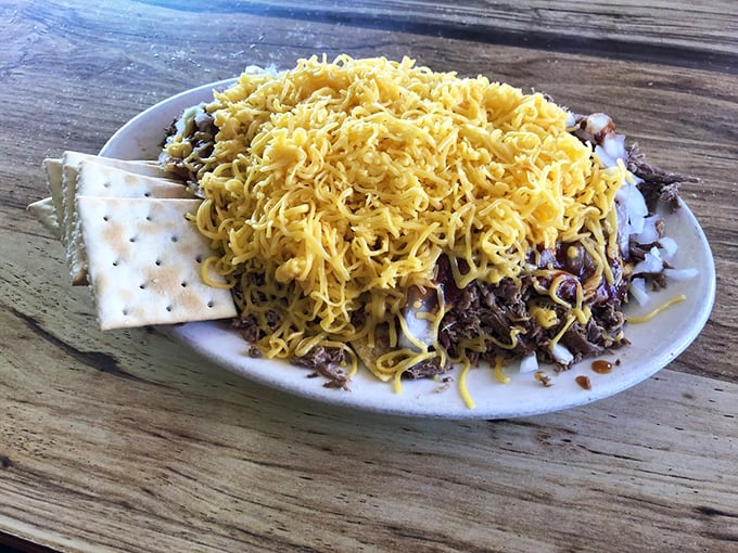 BBQ beef draped in that signature sauce, flanked by creamy slaw and beans. This plate isn't just a meal—it's a Southern meditation.