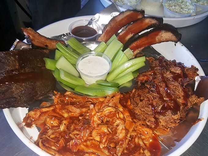 BBQ nirvana on a plate – where ribs, pulled pork, and fresh celery sticks create the holy trinity of smokehouse perfection.