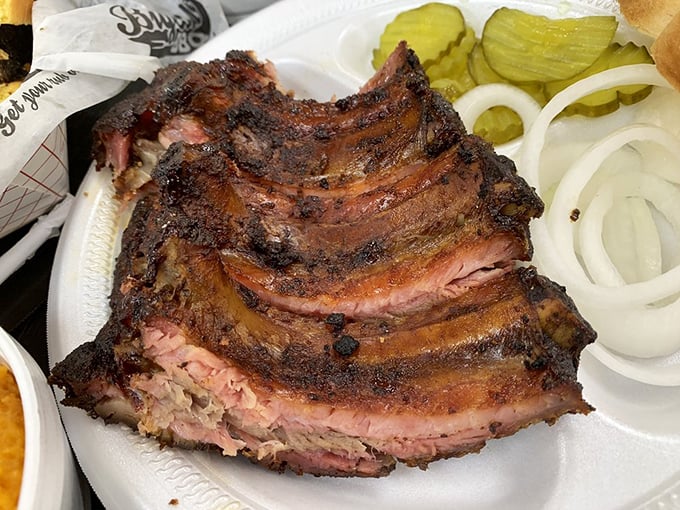 These ribs have the kind of bark that doesn't bite—unless you count biting into flavor so intense it might make you forget your name temporarily.