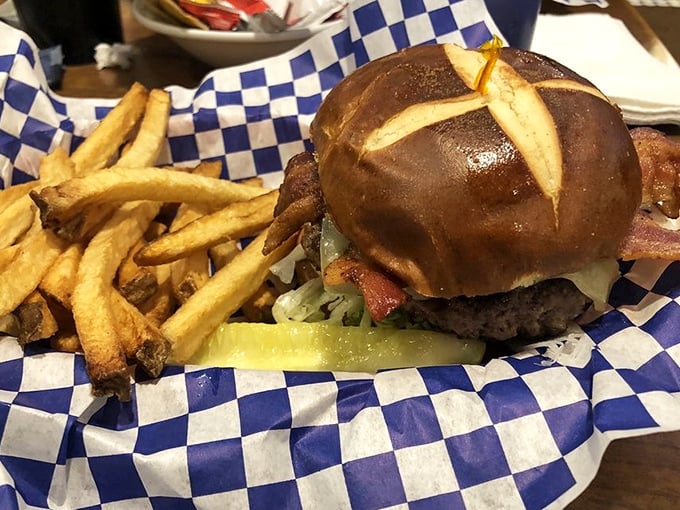 A burger that requires jaw exercises beforehand – that pretzel bun, those hand-cut fries, and a pickle that knows its supporting role perfectly.