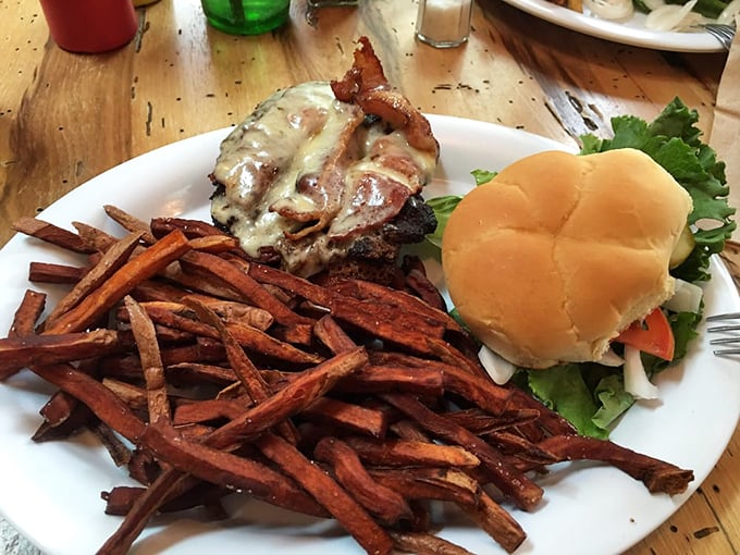 A bacon cheeseburger with sweet potato fries – proof that sometimes the simplest pleasures are the most profound.