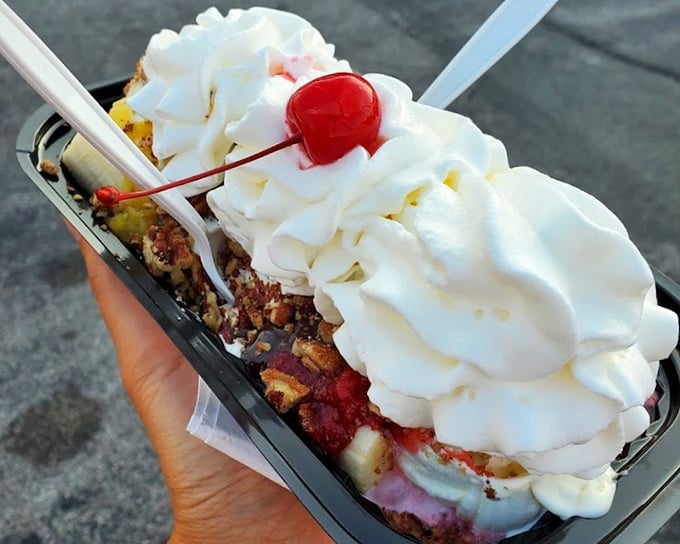 Whipped cream mountains, cherry-topped peaks, and a foundation of frozen custard—this banana split isn't dessert, it's architecture you can eat.