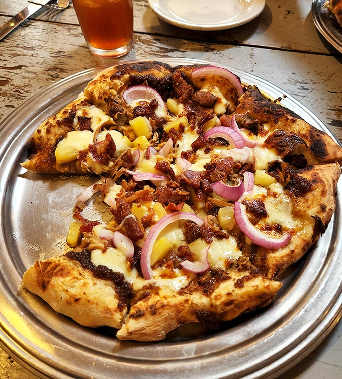 This isn't just pizza—it's a circular argument for why Hawaiian toppings belong, with caramelized pineapple and red onions making the case deliciously.