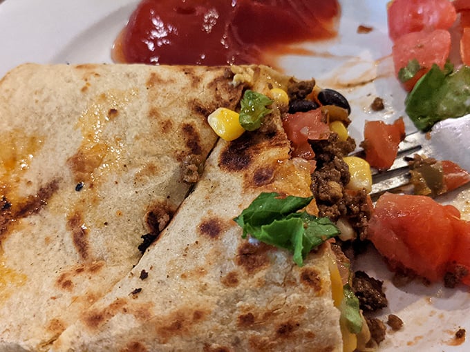 The beef quesadilla arrives looking like it just graduated from comfort food finishing school with honors.