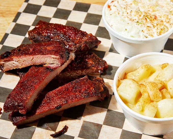 These ribs have that perfect mahogany color that whispers "take me home"—paired with classic sides that know their supporting role.