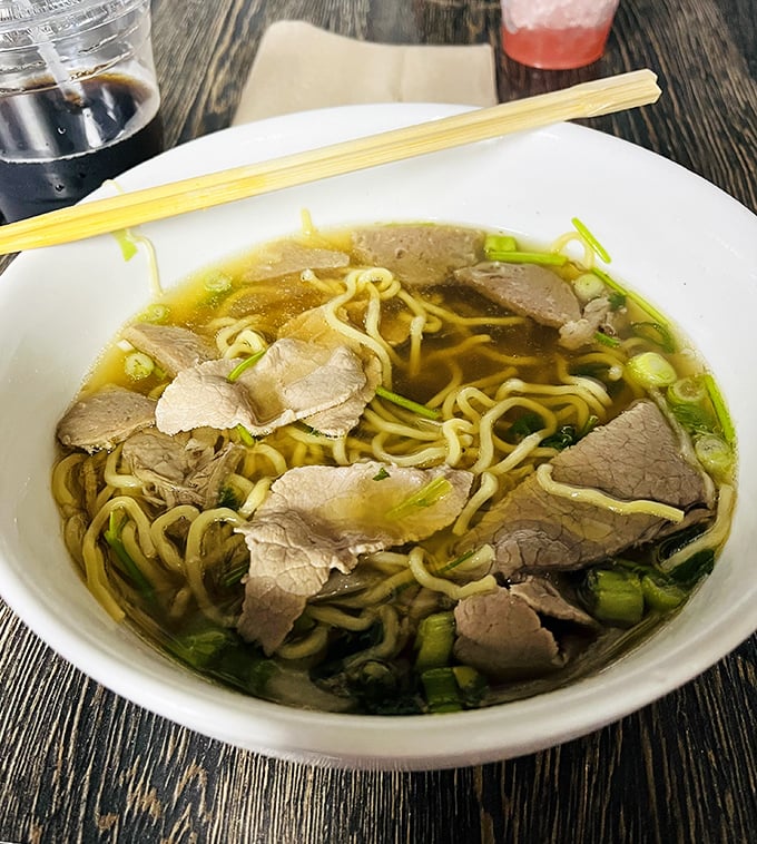 Simplicity at its finest—thin noodles swimming in a golden broth with perfectly sliced beef. Green onions add a fresh pop to this traditional comfort bowl.