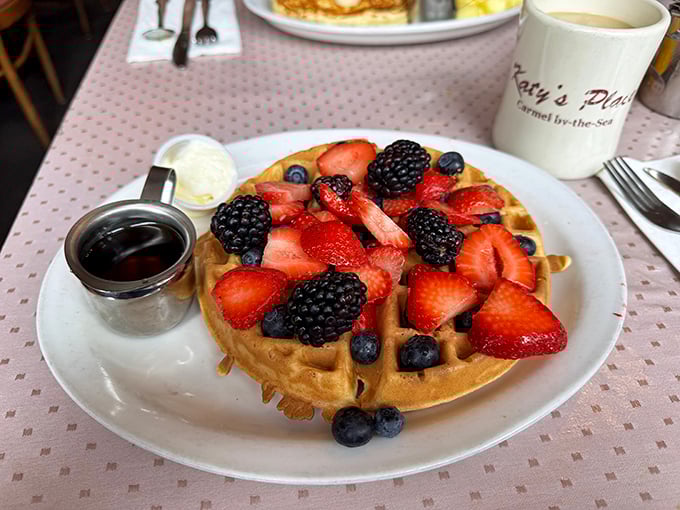 A Belgian waffle crowned with fresh berries looks like summer decided to throw a party on your plate.