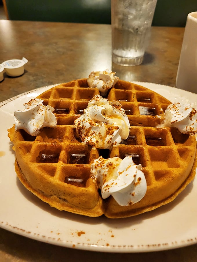 This Belgian waffle with whipped cream dollops isn't just breakfast; it's what clouds must taste like if they were made in a Midwestern kitchen.