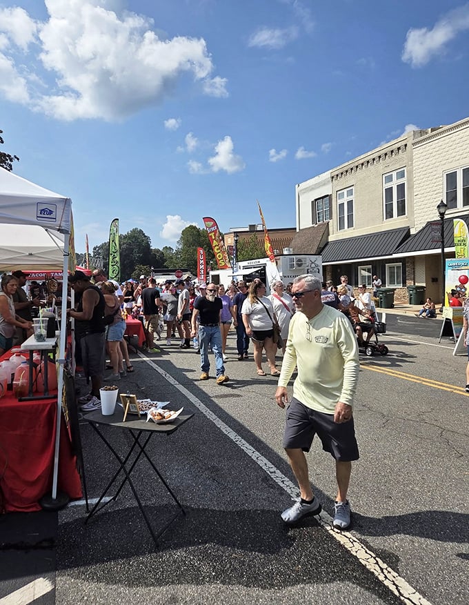 Locals and visitors alike stroll through the Big Red Apple Festival, hunting for treats and treasures under the Georgia sun.