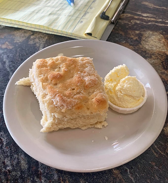 This fluffy biscuit with a side of butter isn't just breakfast – it's a pillow of happiness waiting for your face.