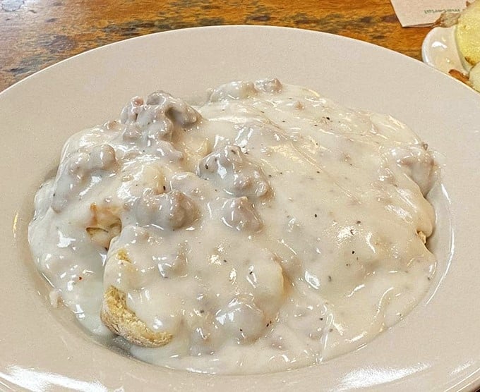 Biscuits and gravy so comforting it could end family feuds – a creamy, peppery blanket covering pillowy biscuits that would make any grandma proud.