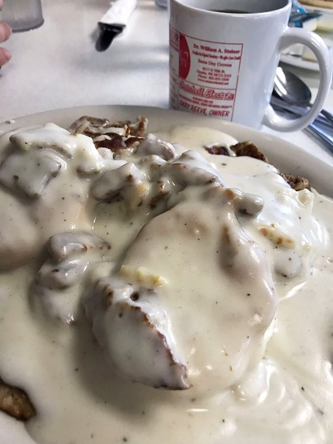 Biscuits and gravy that could make a Southern grandmother nod in approval—creamy, peppery gravy blanketing everything in comforting warmth.