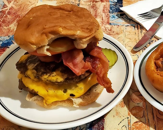 A burger that defies gravity—stacked with bacon, cheese, and all the fixings. Your cardiologist wouldn't approve, but your soul certainly will.