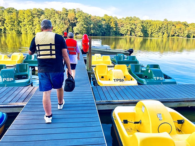 The boat dock at sunset, where colorful paddle boats wait patiently for tomorrow's explorers to create ripples across the glassy surface.