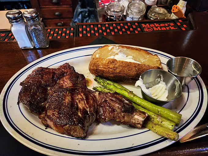 The bone-in ribeye—where primal meets refined. That char speaks of fire-kissed perfection while the asparagus stands by, pretending it's the reason you came.