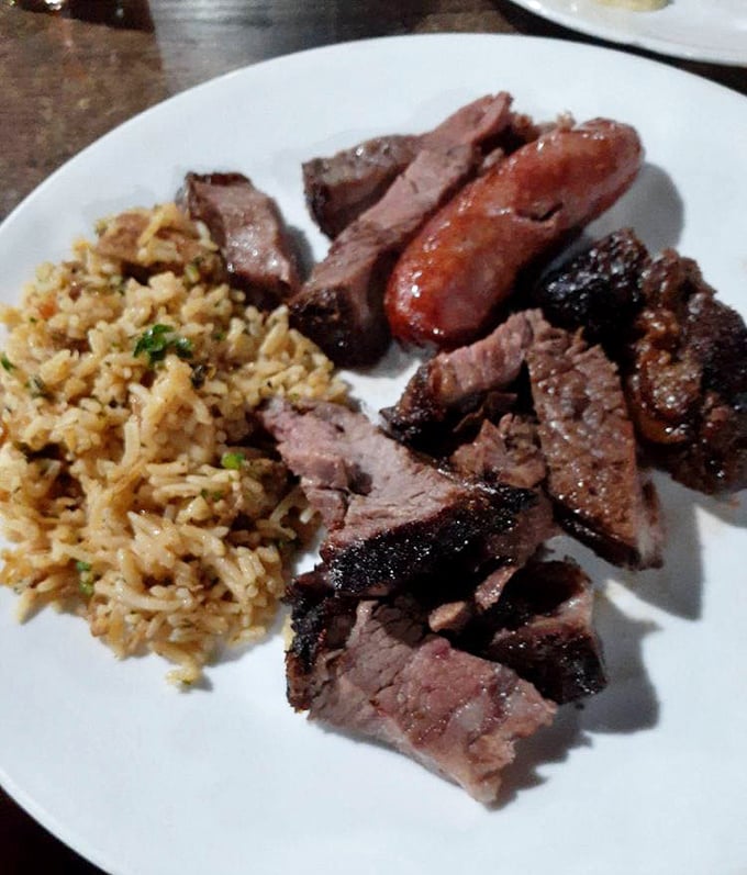 The holy trinity of Brazilian cuisine: perfectly seasoned rice, linguiça sausage, and grilled steak. Simplicity elevated to an art form that needs no translation.