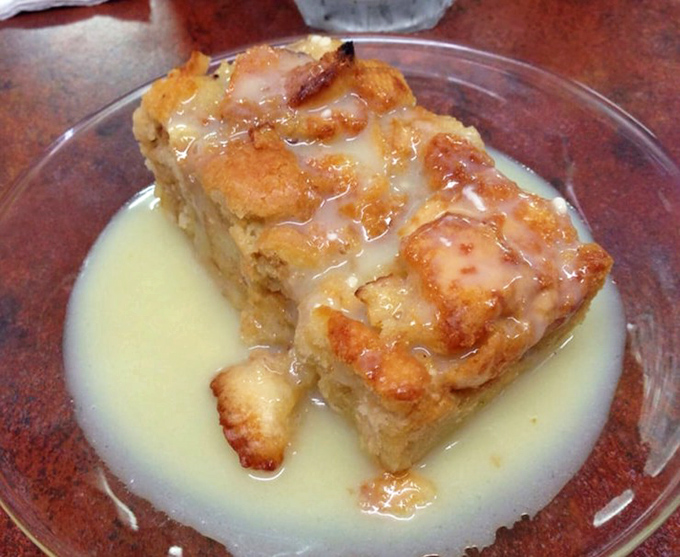 Swimming in vanilla sauce, this bread pudding looks like it could solve world peace, one spoonful at a time.