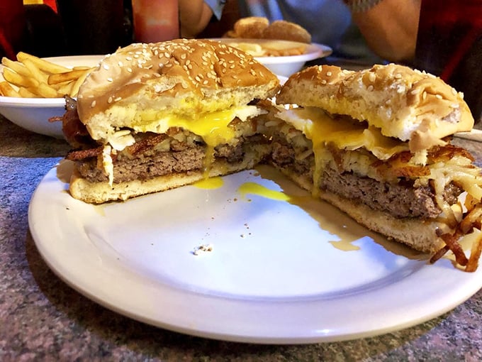 The breakfast burger arrives like a beautiful morning catastrophe – egg yolk ready to cascade over a perfectly seasoned patty.