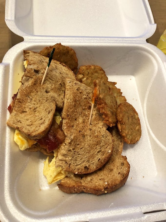 This breakfast sandwich isn't just assembled, it's architected—layers of savory goodness held together by perfectly toasted bread and a toothpick of hope.