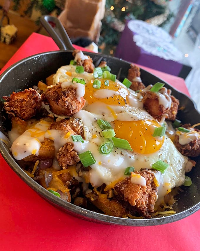 Breakfast alchemy at its finest—crispy potatoes, melted cheese, and perfectly fried eggs topped with crispy chicken. Morning salvation in cast iron. 