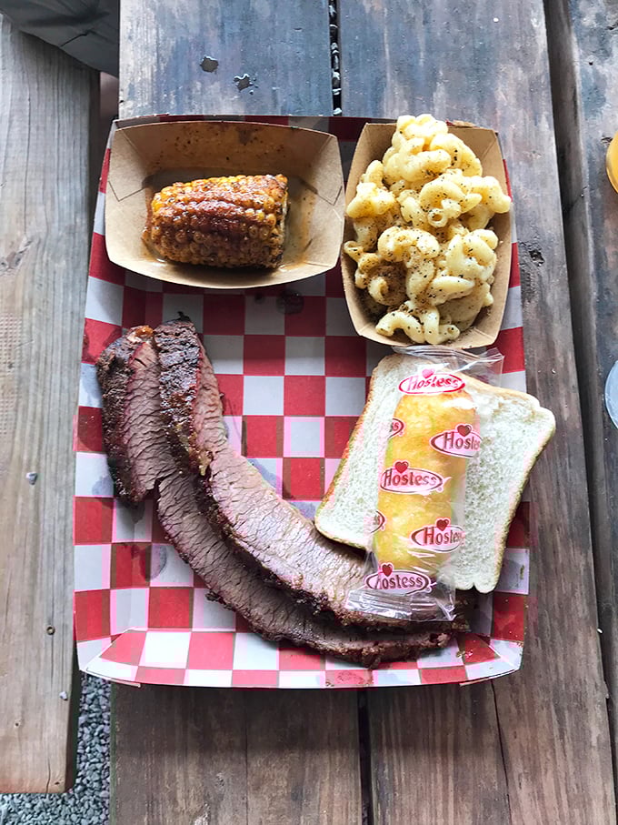 Brisket sliced against the grain reveals that perfect pink smoke ring—visual evidence of the low-and-slow religion practiced by Oklahoma's barbecue faithful.