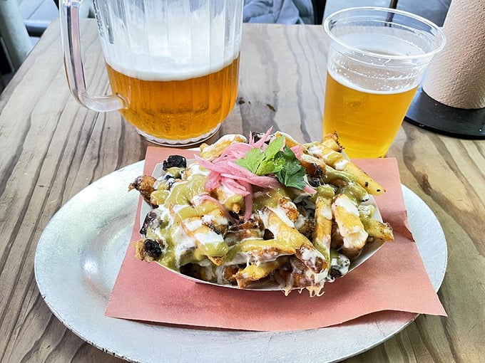 These loaded fries aren't just a side – they're a main event dressed in cheese, topped with pickled onions, and ready for their close-up.