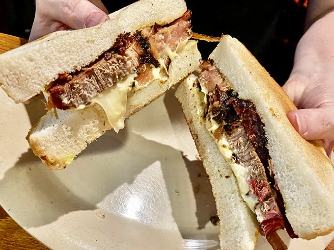 The brisket melt reveals its glorious cross-section – a harmony of tender meat and melted cheese that makes bread the luckiest food group.
