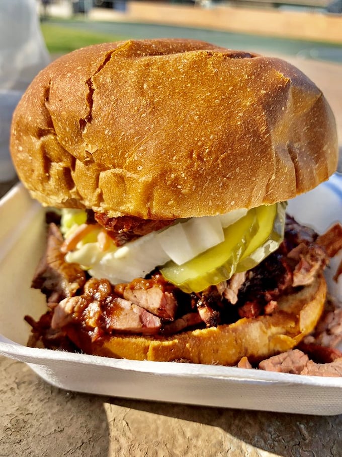 The brisket sandwich that launched a thousand return trips. Tender smoked meat, tangy pickles, and onions on a pillowy bun—simple perfection.