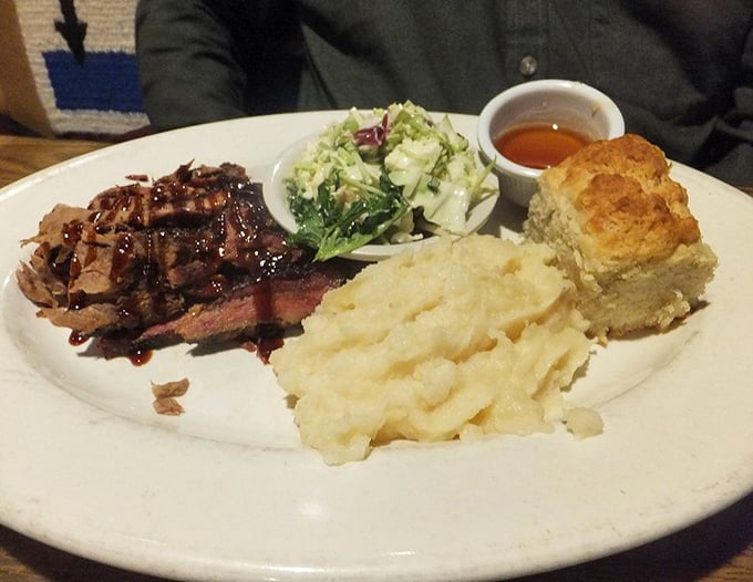 The brisket doesn't just fall apart—it surrenders with dignity. Those garlic mashed potatoes and homemade biscuit are worthy companions.