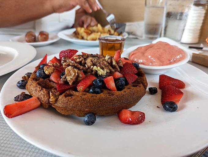 A buckwheat waffle that's throwing a berry party and everyone's invited – especially that strawberry red carpet and blueberry VIP section.