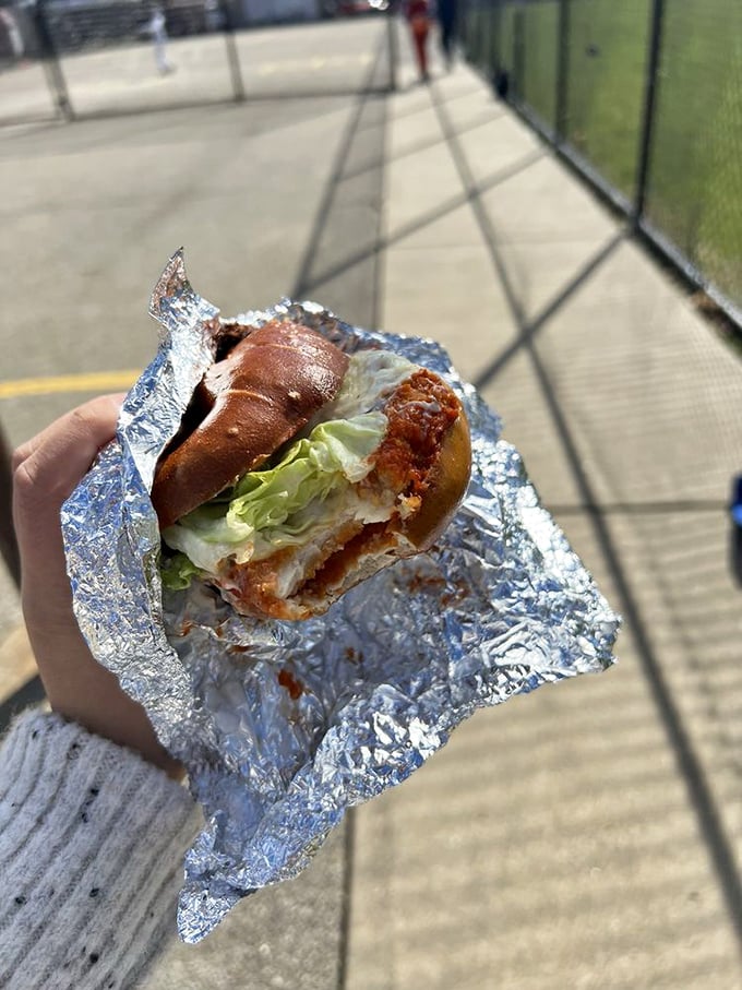 This isn't just lunch—it's a crispy, savory masterpiece where pretzel dough meets crispy chicken and fresh lettuce for sidewalk dining perfection.