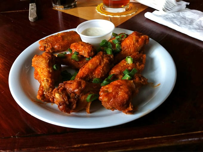 These buffalo wings aren't just crispy—they're having a meaningful relationship with that sauce while the green onions add a fresh pop of color.