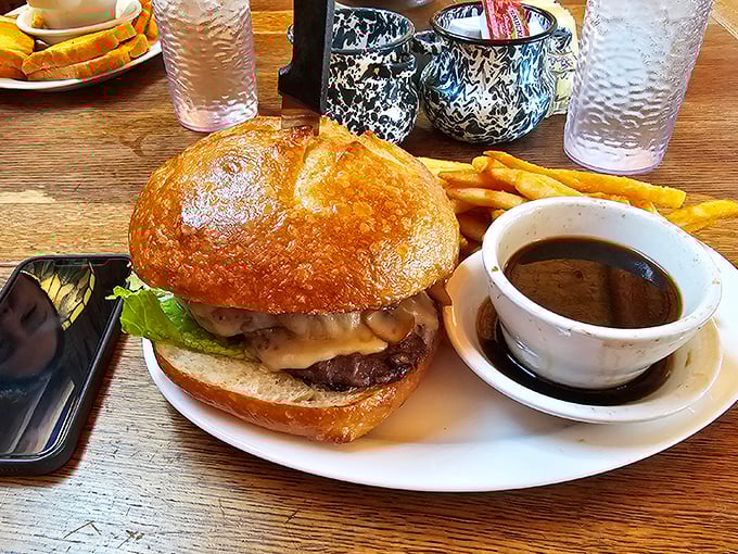 Burger architecture at its finest – a golden dome of brioche cradling a juicy patty with all the fixings. The side of au jus is the plot twist I didn't know I needed.