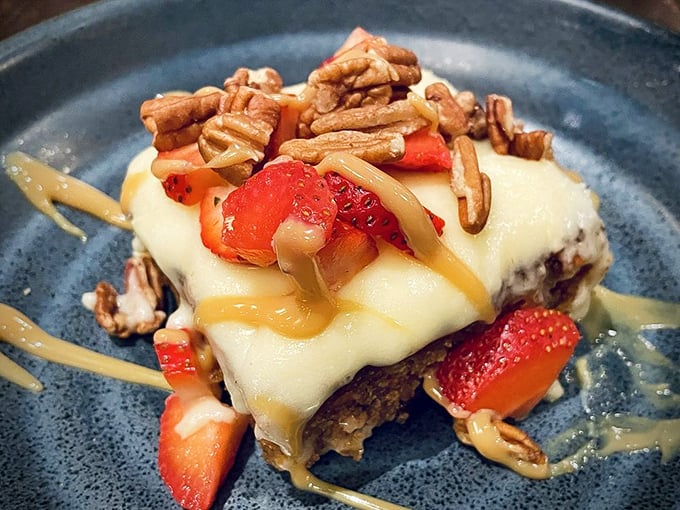Not just dessert – it's a structural marvel of cream cheese frosting, strawberries, and pecans that would make Frank Lloyd Wright weep with joy.