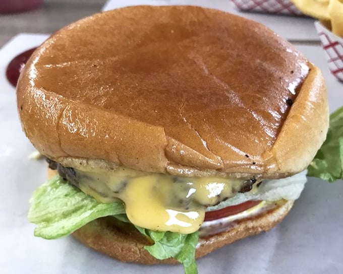 Behold, the Johnson's cheeseburger in all its glory—where lettuce, tomato, and melted cheese meet a perfectly seasoned patty. Poetry on a bun.