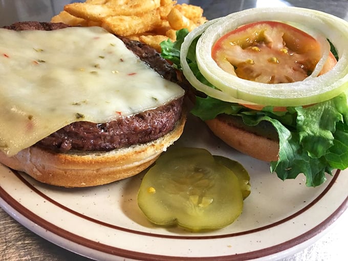 A cheeseburger that doesn't need fancy toppings to impress – just honest beef, melty cheese, and a pickle that knows its supporting role.