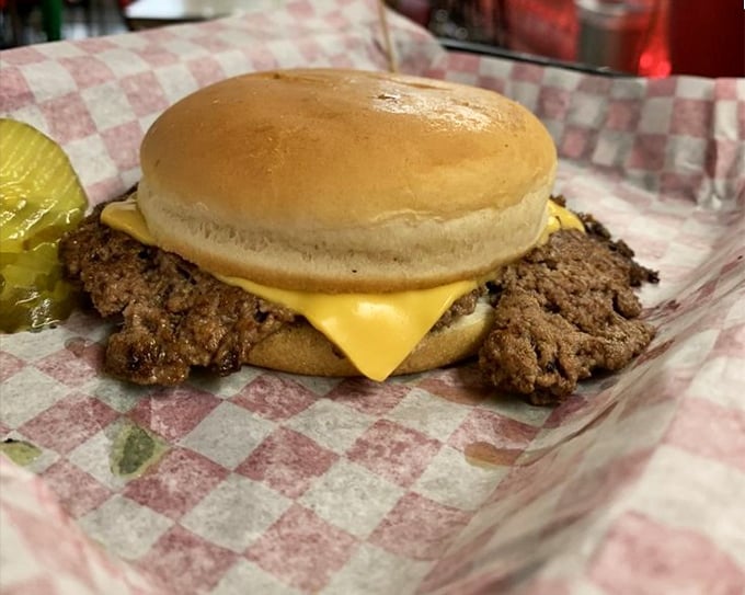 Behold the cheeseburger in its natural habitat—crispy-edged patty with melted American cheese on a simple bun. No pretension, just perfection.