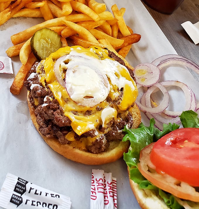 The burger that launched a thousand road trips. That melted cheese cascading down the sides isn't just decoration – it's edible artwork.