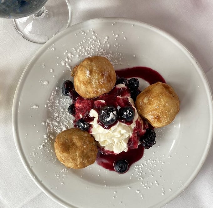 Dessert nirvana: golden beignets surrounding a berry-crowned cloud of cream – proof that heaven might actually be a place on earth.