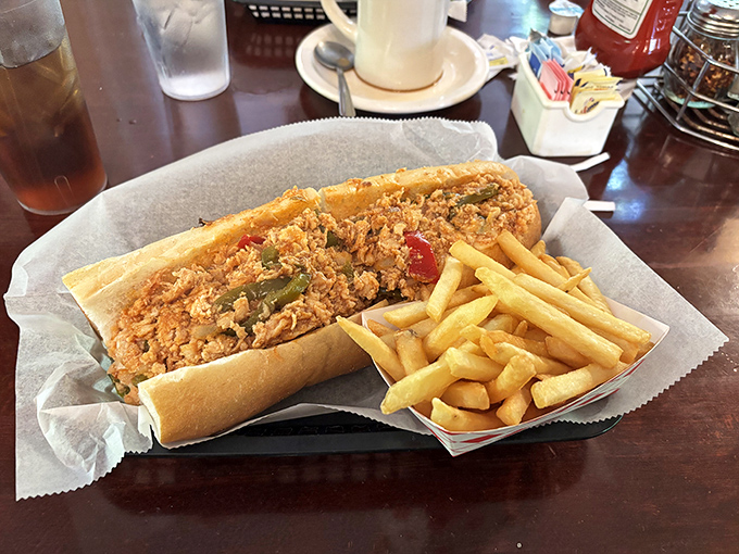 The cheesesteak arrives like a Pennsylvania celebrity—golden fries standing by as loyal sidekicks to this hearty sandwich that demands both hands and your full attention.