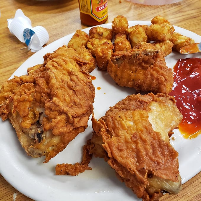 Fried chicken that's audibly crunchy from three tables away, golden-brown and glistening like it just won a beauty pageant for comfort food.